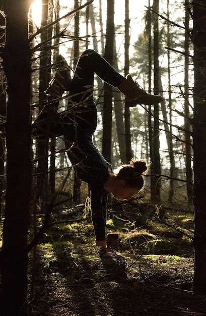 Premium Photo Woman Doing Handstand In Forest