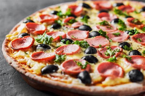 Pizza With Mozzarella Cheese Olives Ham Tomato Sauce Sausage