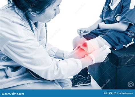 Sports Injury Doctor Makes Bandage On Knee Patient On White Ba Stock