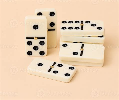 A Stack Of Dominoes On A Beige Background An Intellectual Game