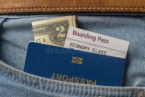 Dollars Blue Passport And Boarding Pass In Your Pocket Jeans Close Up