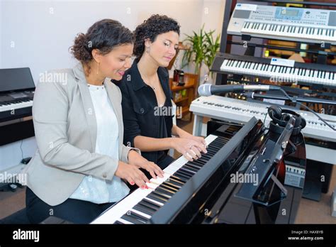 Two Women Playing Keyboard Stock Photo Alamy