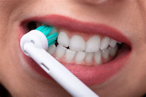 Woman Brushing Teeth With Electric Toothbrush Stock Image Image Of