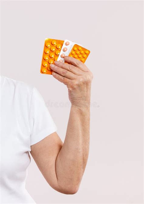 Elderly Senior Woman With Tablets Vitamins Or Supplements In Hand Treatment Or Strengthening