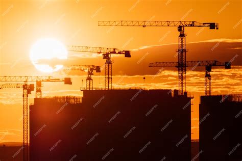 Premium Photo Crane And Building Silhouettes At Sunrise