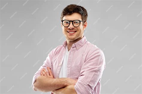 Premium Photo Smiling Young Man In Glasses Over Grey Background