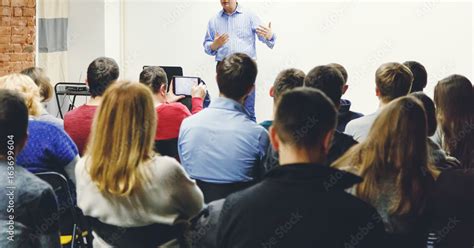 Adult Students Listen To Professors Lecture In Small Class Room