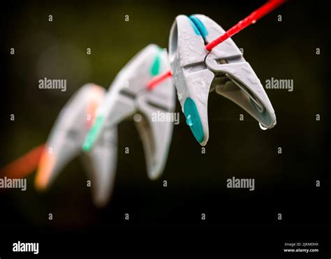 Graphic Image Of Clothes Pegs On A Washing Line After A Shower Of Rain