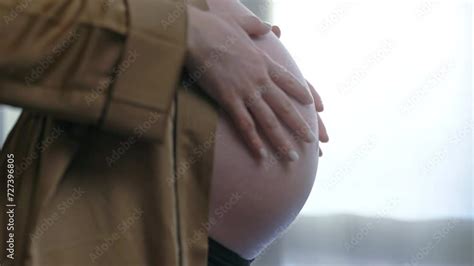 Vidéo Stock Pregnant woman touching and caressing belly. Close up shot of a pregnant girl gently ...