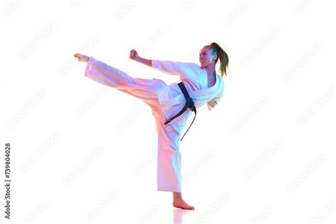 Professional Kung Fu Fighter Woman Show High Kick Pose In Neon Light
