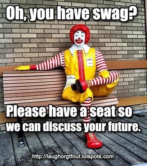 Ronald Mcdonald Statue On Wooden Bench