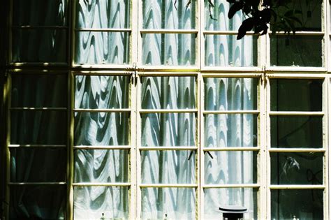 Premium Photo Low Angle View Of Glass Window Of Building