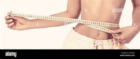 Slim Girl With Centimeter Closeup Woman Measuring Her Waist With Tape