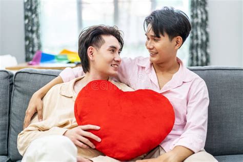 Portrait Of Happy Gay Couple Showing Their Love With Rainbow Flag
