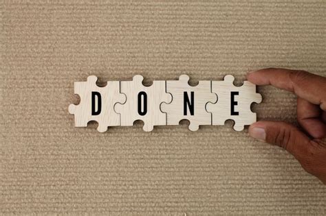 Premium Photo Wooden Puzzle With The Word Done Concept Is Complete