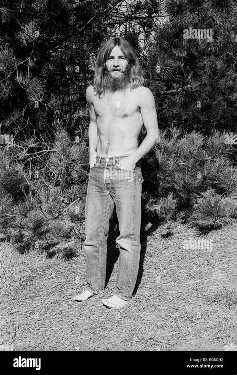 Portrait Of Hippie Man With A Beard And Long Hair Standing With Bare