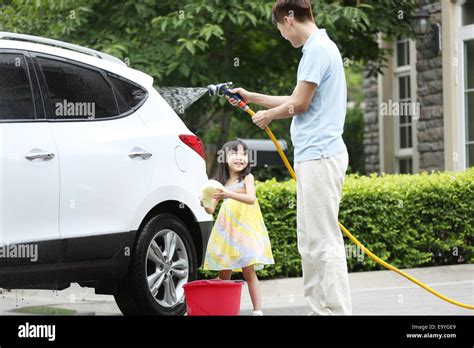 Girl Helping Father Cleaning Car Stock Photo Alamy