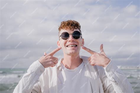 Premium Photo A Young Guy Shows His Fingers On The Braces On His