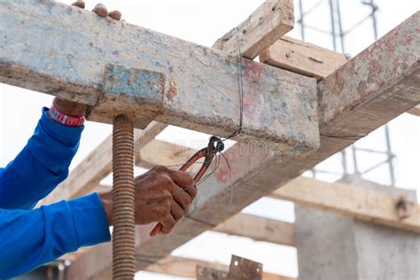 Workers Use Scaffolding Wire To Support The Floor Pouring Concrete