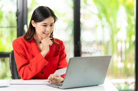 Analytical Research Concept Asian Woman Using Calculator And Laptop To Do Finance Mathematics