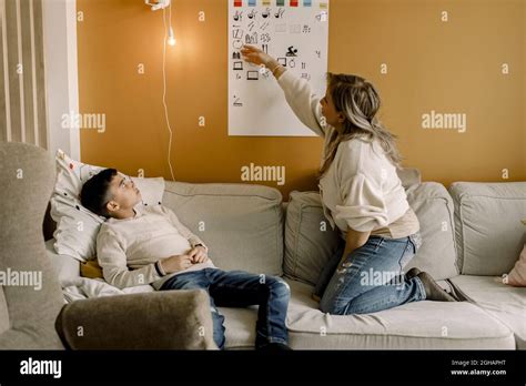 Mother Teaching Autistic Son In Living Room Stock Photo Alamy