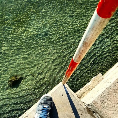 Premium Photo Low Section Of Person Standing On Steps By Sea