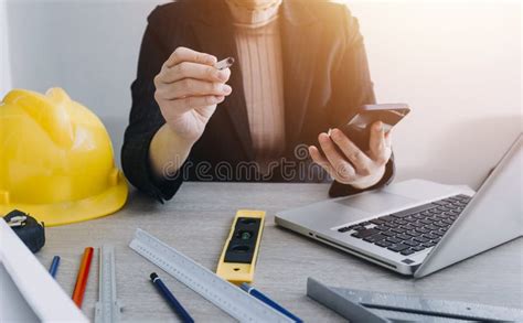Construction Engineer Working At Blueprint To Build Large Commercial