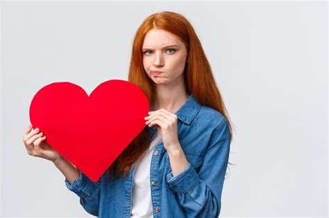 Premium Photo Portrait Of Woman Holding Heart Shape Over White Background
