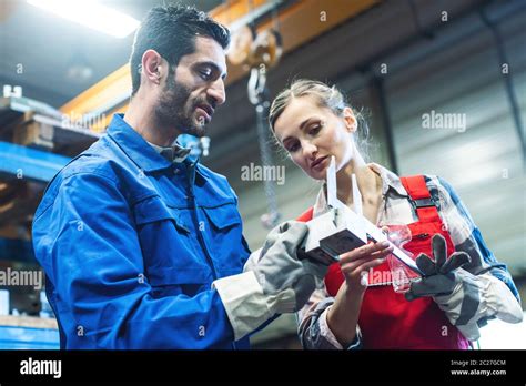 Satisfied Woman And Man Worker Checking Measurements Of Metal Work Piece Stock Photo Alamy