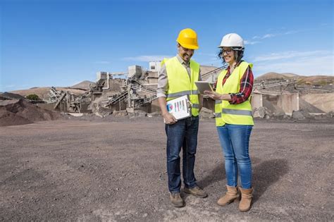 Premium Photo Full Body Of Positive Female Engineer Showing Tablet To Male Colleague And