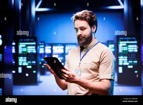 Administrator In Front Of Server Rackmounts Delivering Web Content To