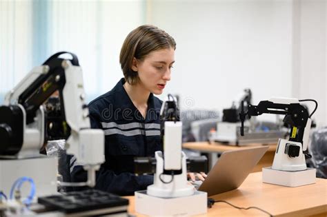 Female Technician Engineer Using Laptop Checking And Operating Stock