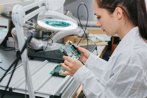 Computer Expert Professional Technician Examining Board Computer In A Laboratory In A Factory