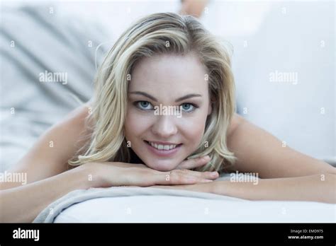 Portrait Of Smiling Blond Woman Lying On A Couch Stock Photo Alamy