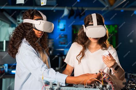 Premium Photo Two Young Women In Vr Glasses Doing Experiments In Robotics In A Laboratory