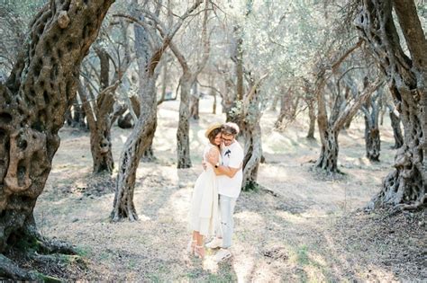 Premium Photo Man And Woman Hugging While Standing In An Olive Grove