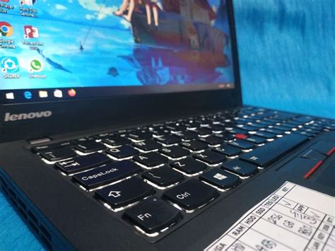 An Open Laptop Computer Sitting On Top Of A Blue Table