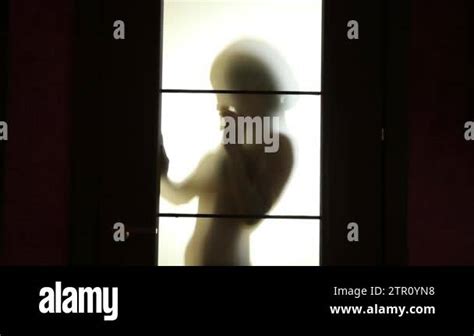 Seductive Woman Dances Behind Blurry Glass Door Sexually Holding Glasses Stock Video Footage