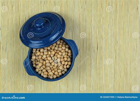 Chickpeas In In Blue Bowl On A Straw Background Vegetarian Organic