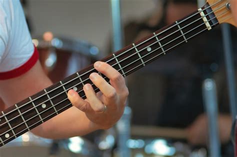 Premium Photo Fingers On Strings Of An Electric Bass Guitar