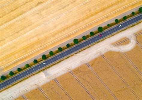 Premium Photo Aerial View Of A Country Road Between Agricultural