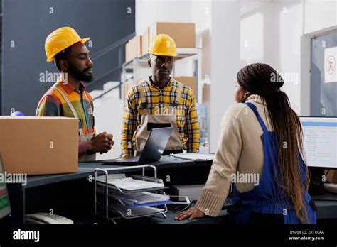 Storehouse Employees Discussing Pacel Delivery Delay With Shipment