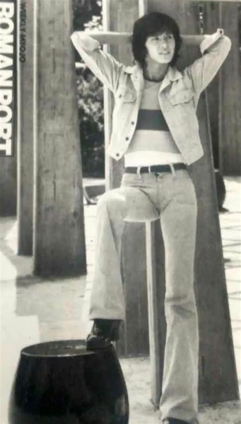 An Old Black And White Photo Of A Person Standing Next To A Barrel With