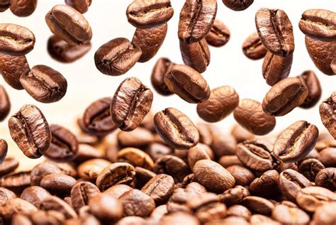 Premium Photo Falling Coffee Beans Isolated On White