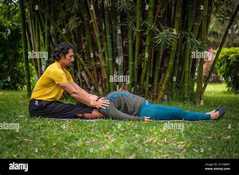 Thai Massage Therapy Session Outdoors With Bamboo Background Man And