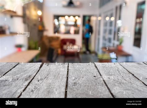 Selective Focus Of Wooden Table With Blur Coffee And Restutant Cafe