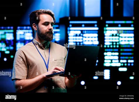 Meticulous Engineer Inspecting Operational Server Rows In Computer