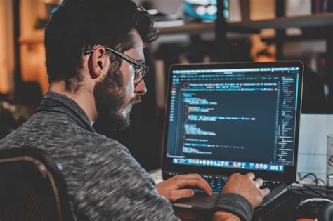 Premium Photo A Developer Writes Code On His Laptop Inside The Office Develop Software For