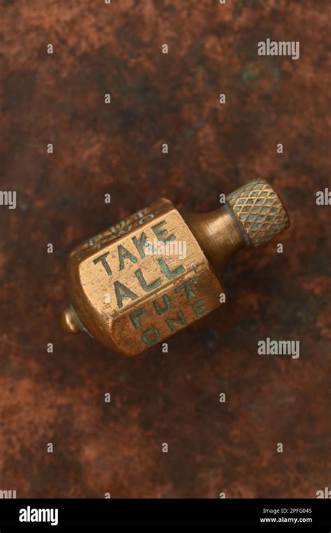 Sepia Image Of Brass Disc Spinner With Words Stating Tale All Facing