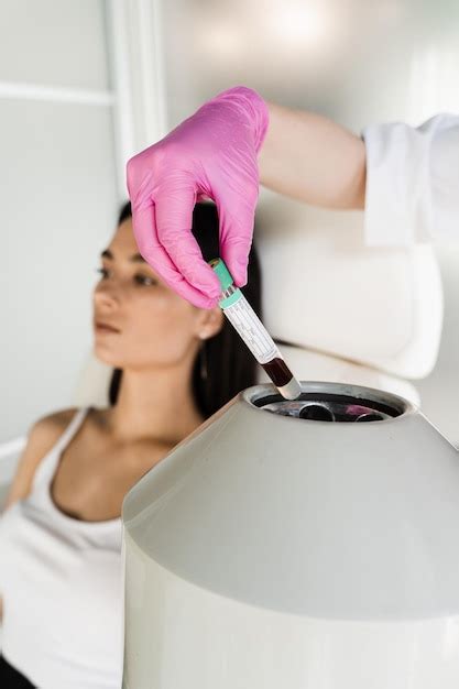 Premium Photo Cosmetologist Insert Test Tube With Blood In Centrifuge
